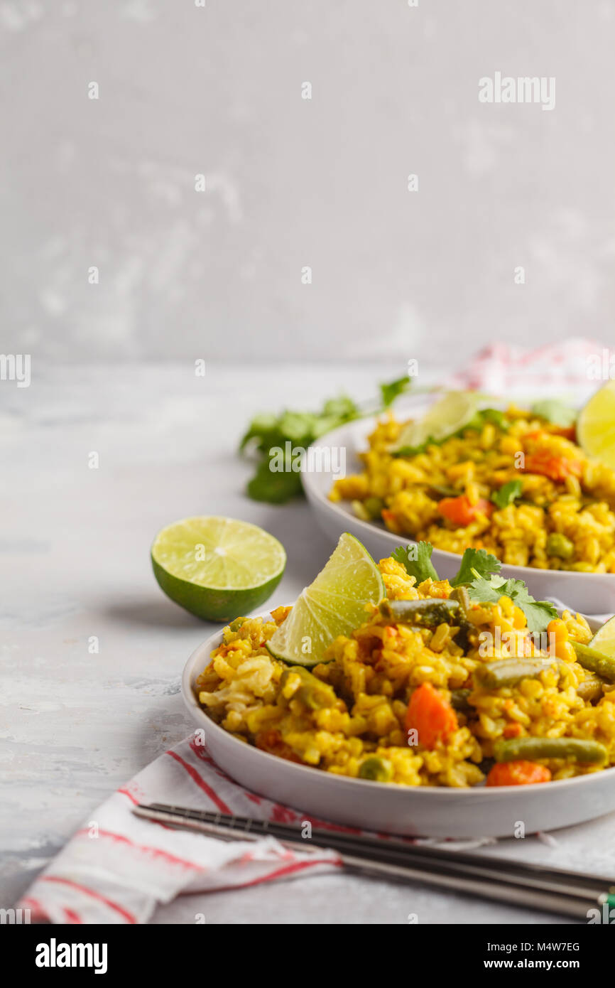 Vegetarian curry rice with vegetables and coconut cream in gray plates ...