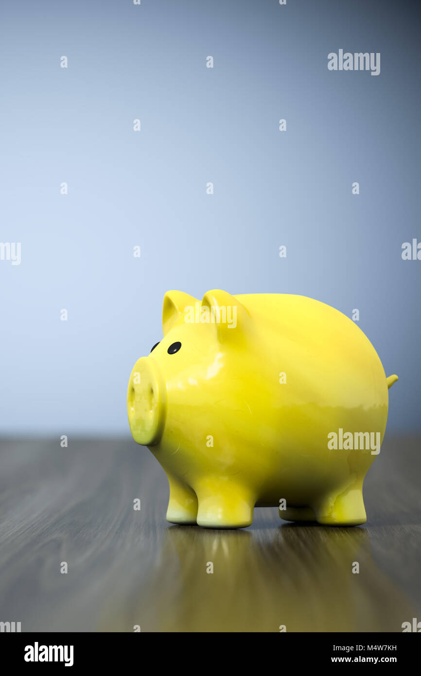 yellow piggy bank background Stock Photo - Alamy