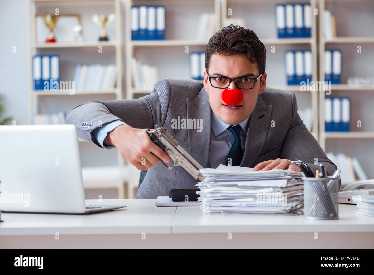 Clown businessman working in the office angry frustrated with a Stock ...