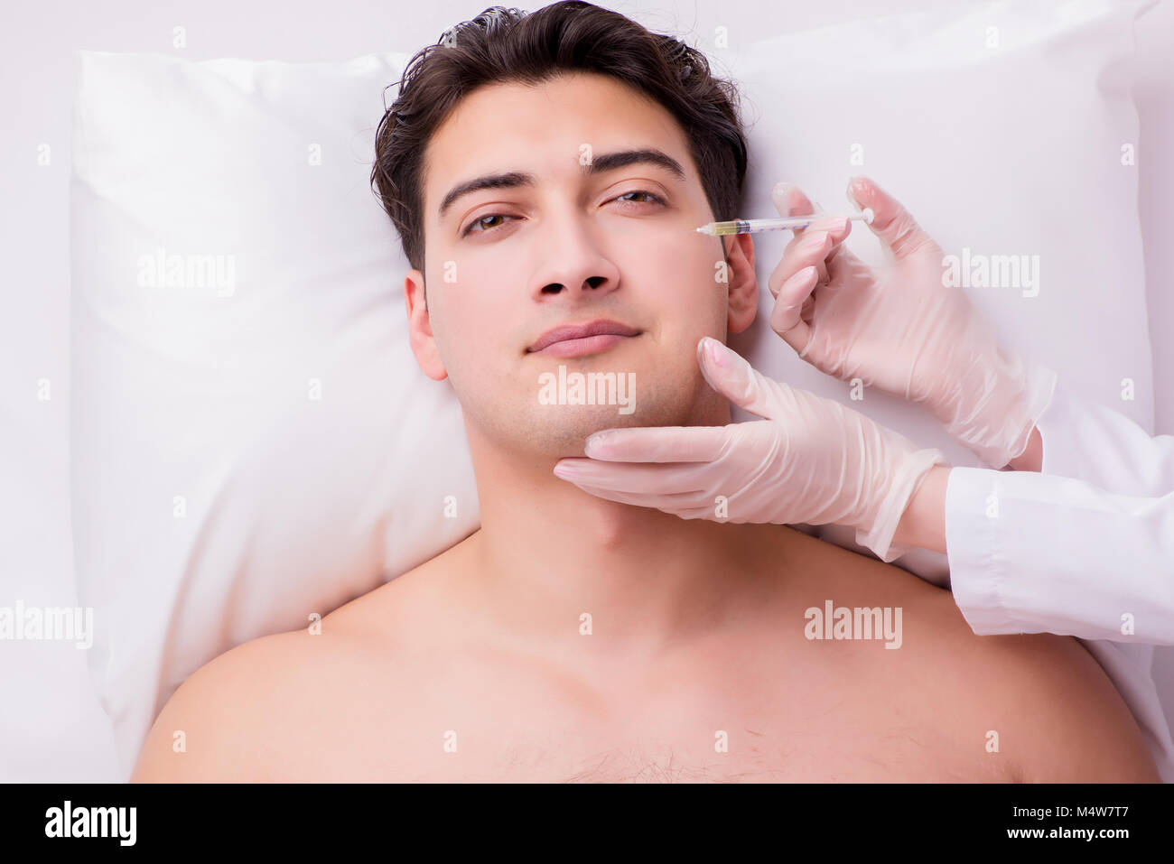 Handsome man in spa massage concept Stock Photo - Alamy