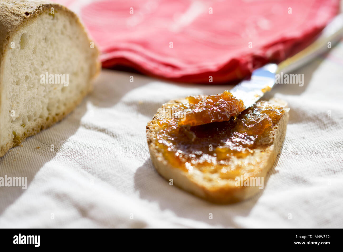 strawberry jam spread on a slice of bread Stock Photo - Alamy