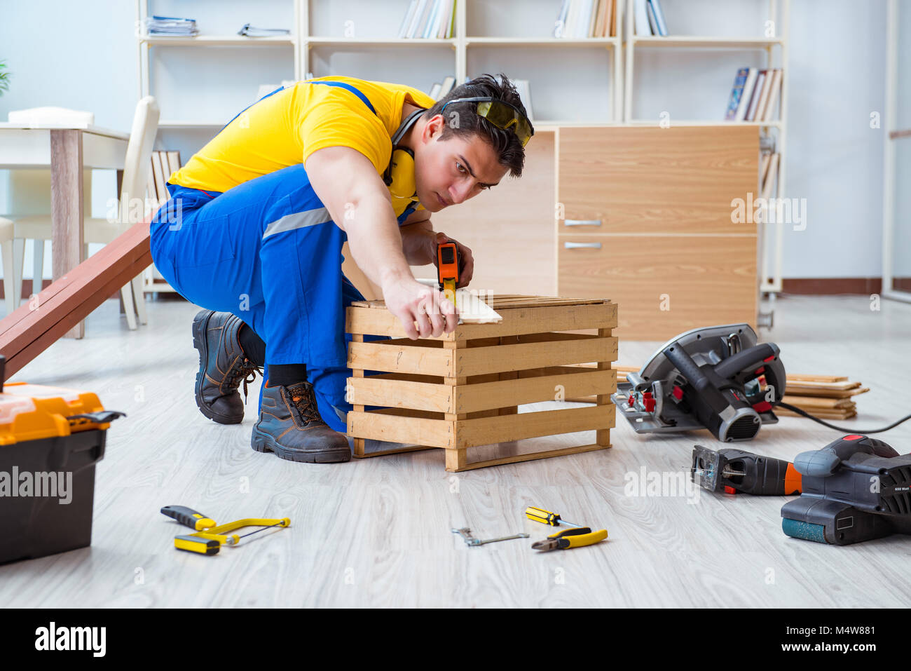 Repairman carpenter working with wooden board plank and measurin Stock ...
