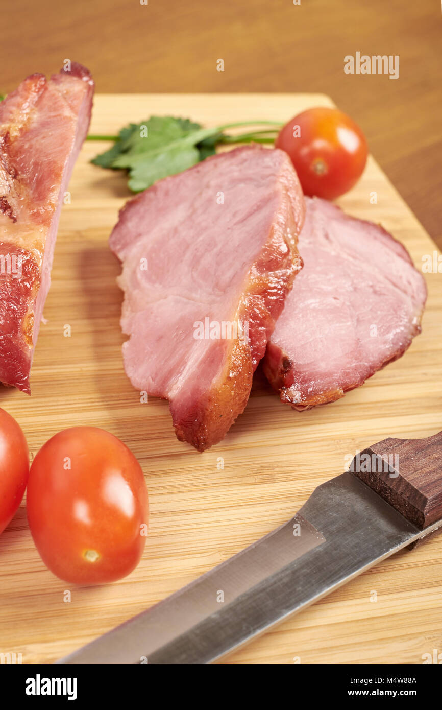 Cooked sliced pork barbecue steak on wooden cutting board Stock Photo ...