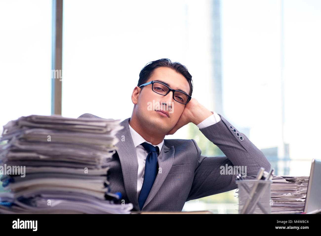 Busy angry businessman with heaps of paper Stock Photo - Alamy