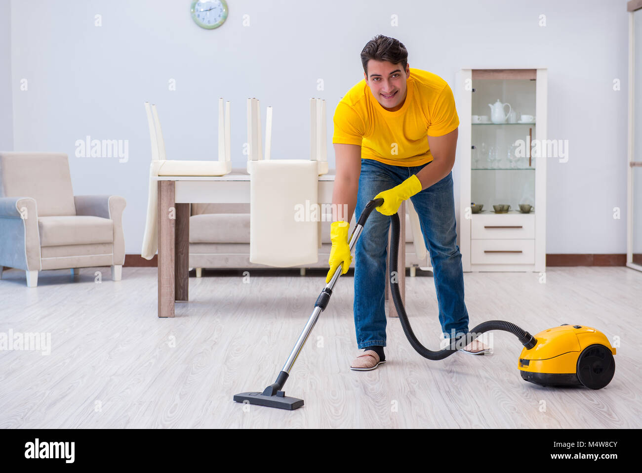 Cheerful husband doing household chores hi-res stock photography and ...