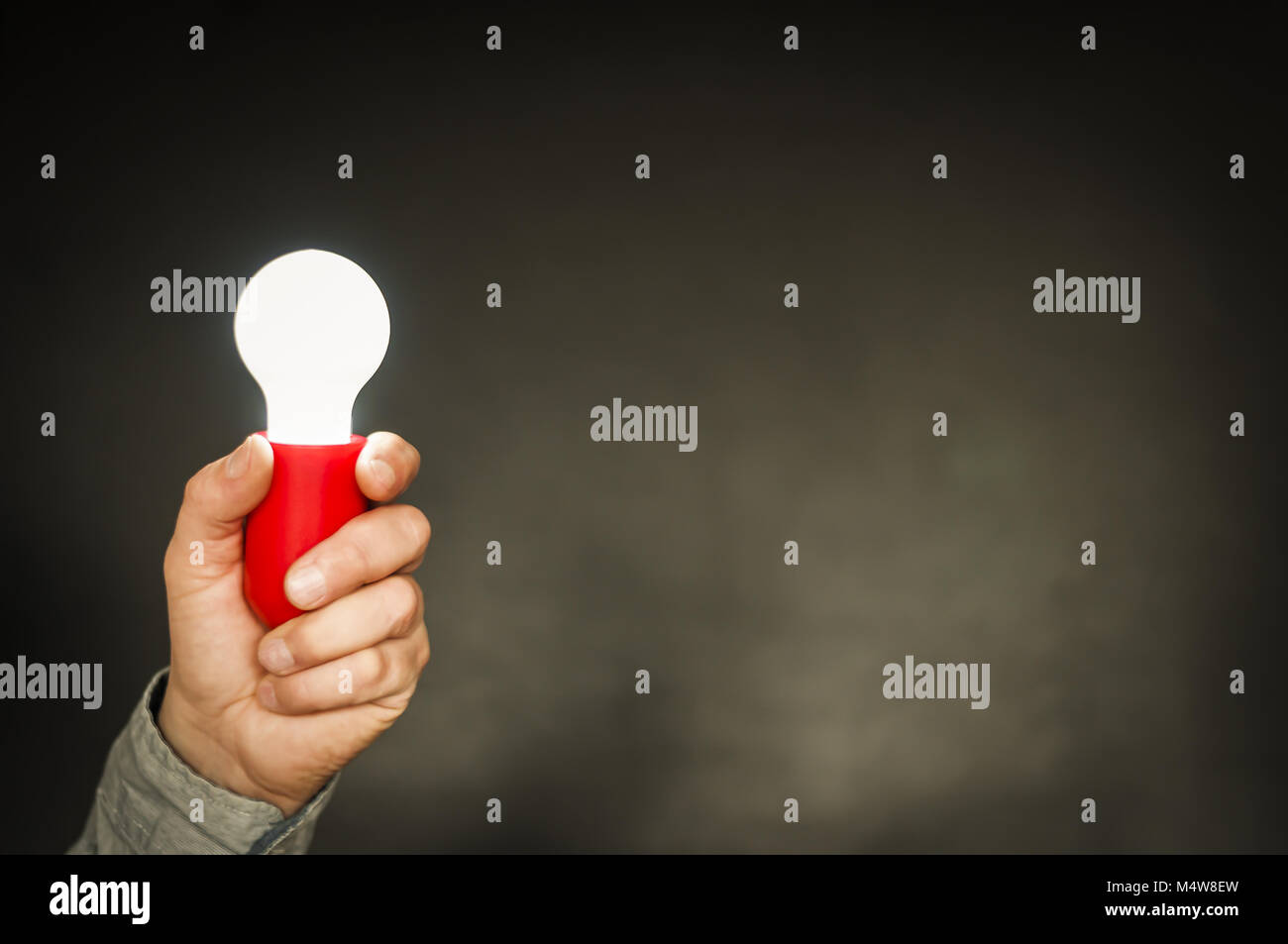 Hand with light bulb Stock Photo - Alamy