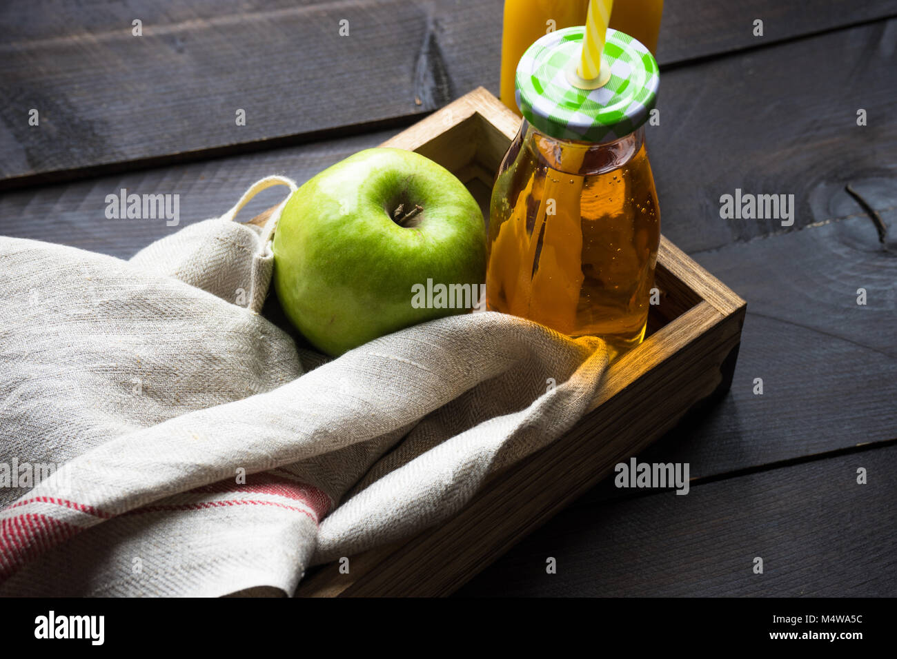 Wooden rustic box with vintage bottles of organic fruit juice on dark ...
