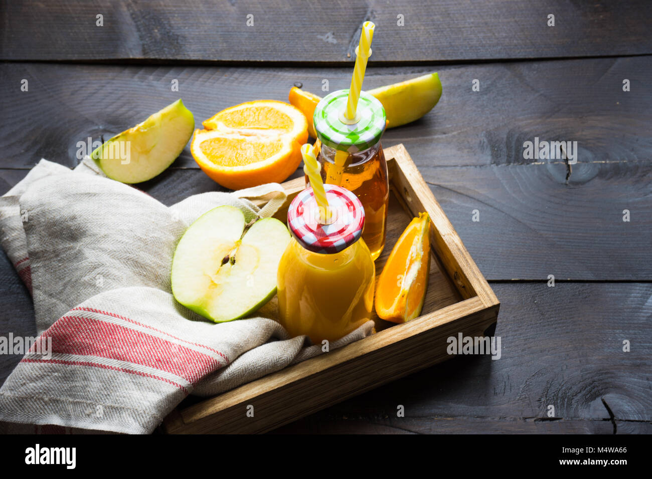 Wooden rustic box with vintage bottles of organic fruit juice on dark ...