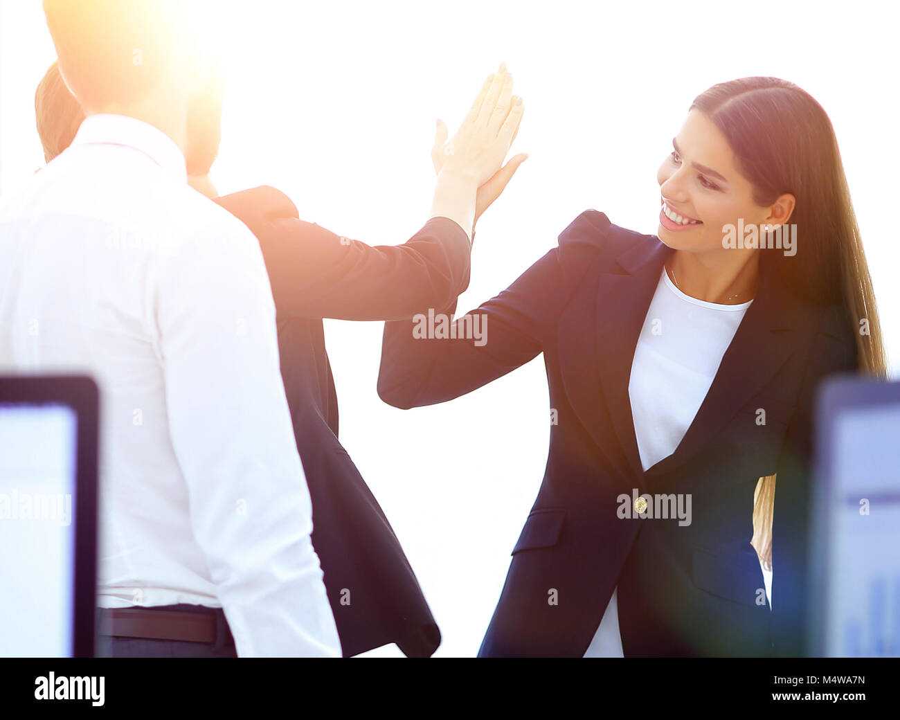employees giving each other high five Stock Photo - Alamy