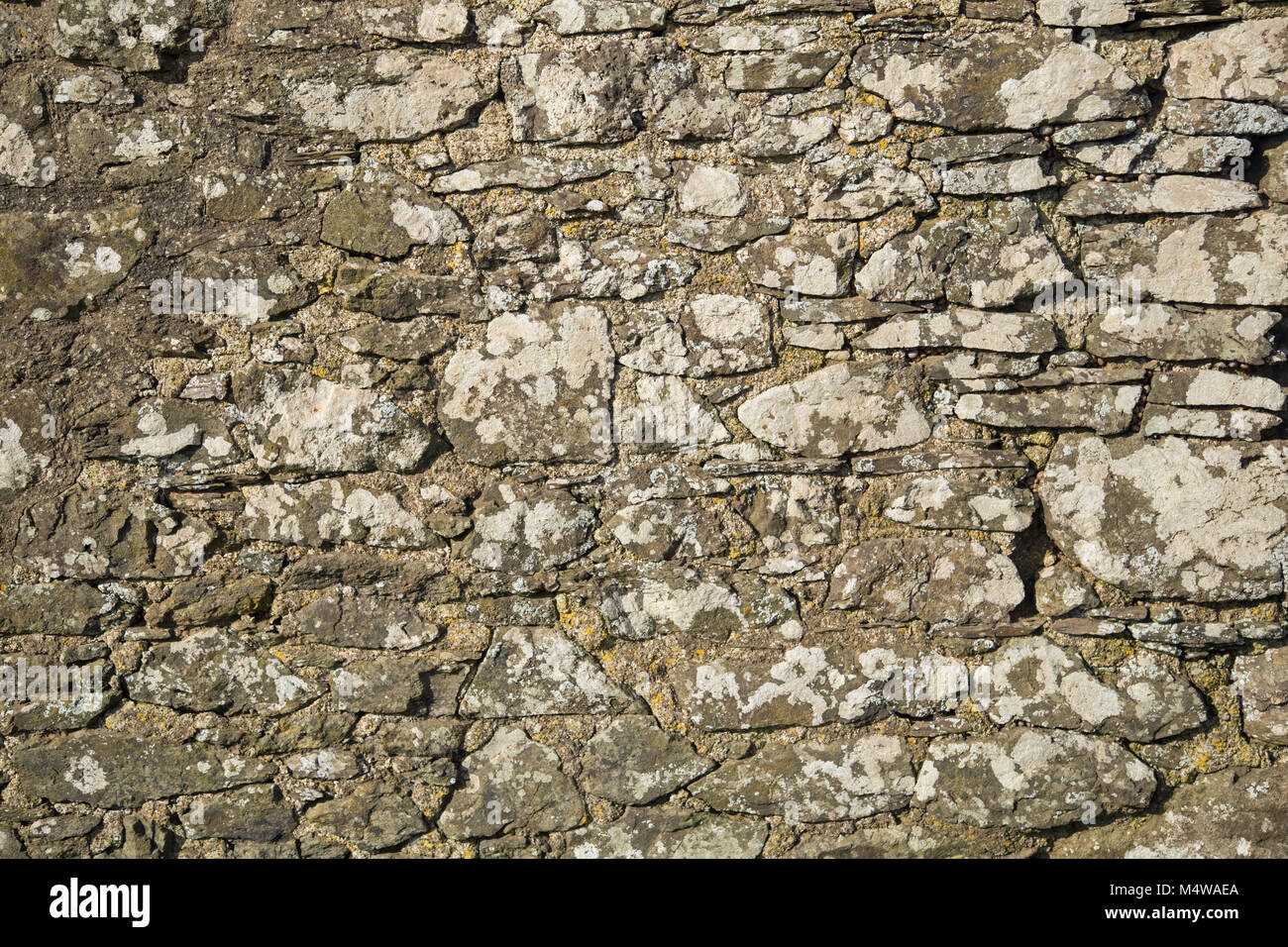 Weathered stone wall background Stock Photo - Alamy