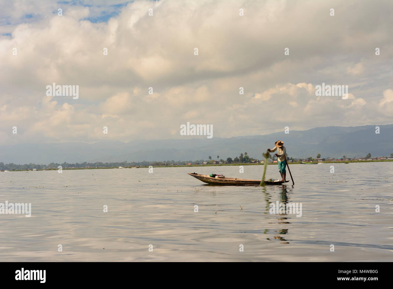 Nyaung Shwe: fisherman at Inle Lake, fishing net, leg rowing style ...