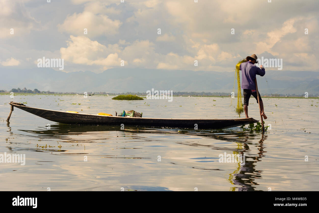 Nyaung Shwe: fisherman at Inle Lake, fishing net, leg rowing style ...