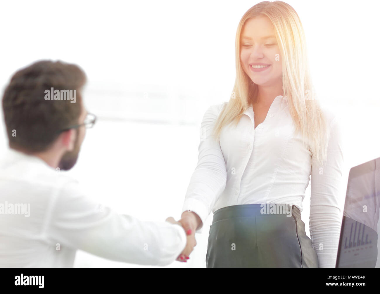 handshake Manager with a colleague near the desktop Stock Photo - Alamy