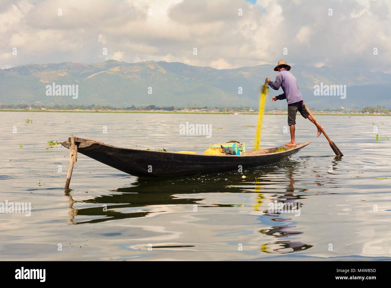 Nyaung Shwe: fisherman at Inle Lake, fishing net, leg rowing style ...