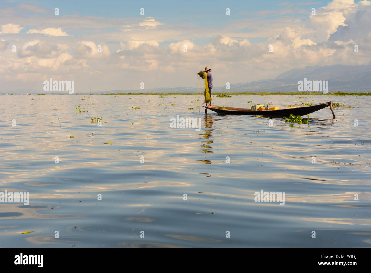 Nyaung Shwe: fisherman at Inle Lake, fishing net, leg rowing style ...