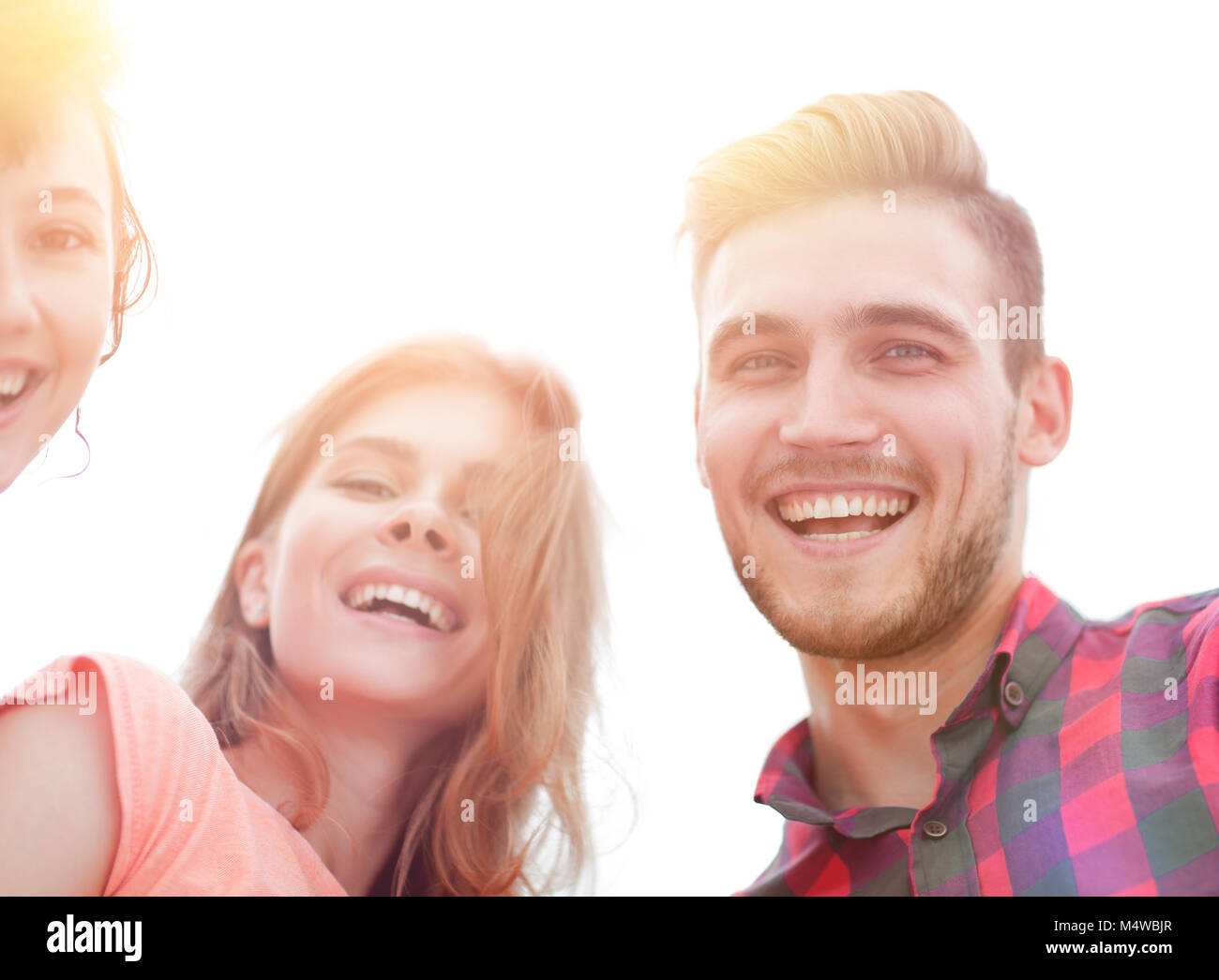 closeup of three young people smiling on white background Stock Photo ...