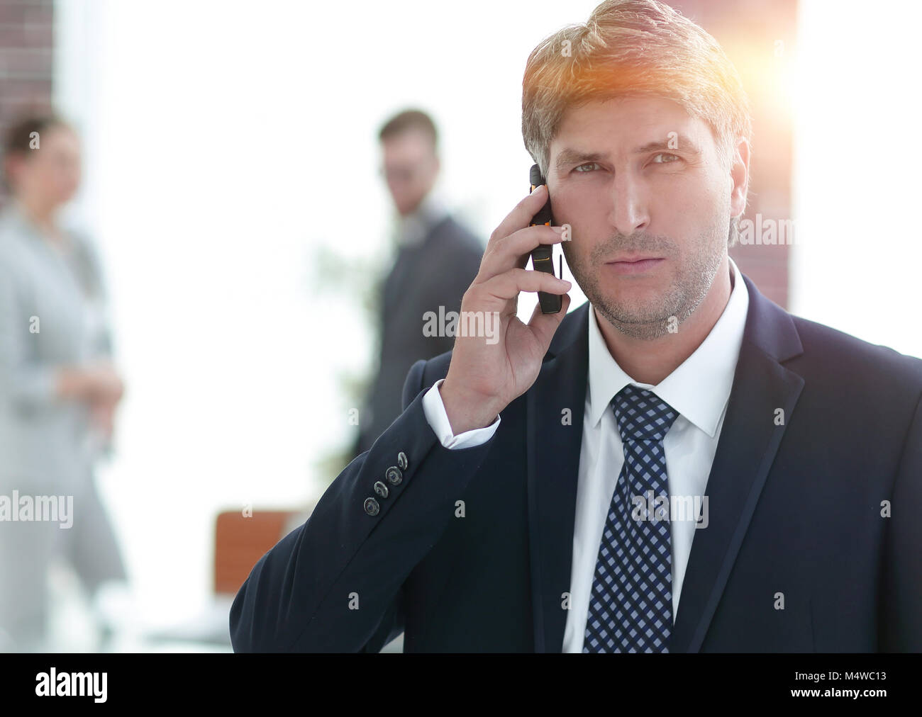Serious businessman talking on the phone Stock Photo - Alamy