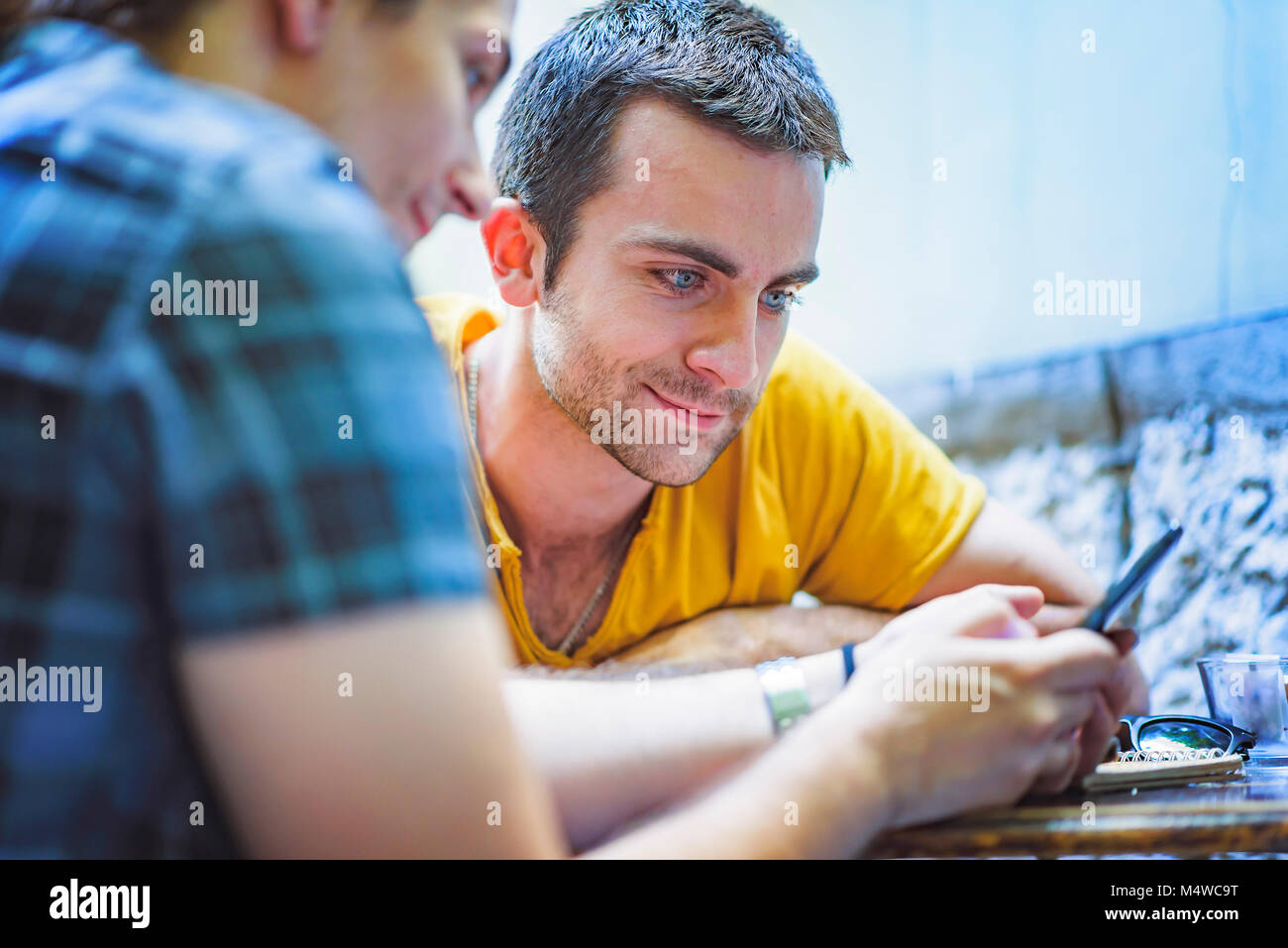 Outdoor coffee shop, two male friends Stock Photo - Alamy