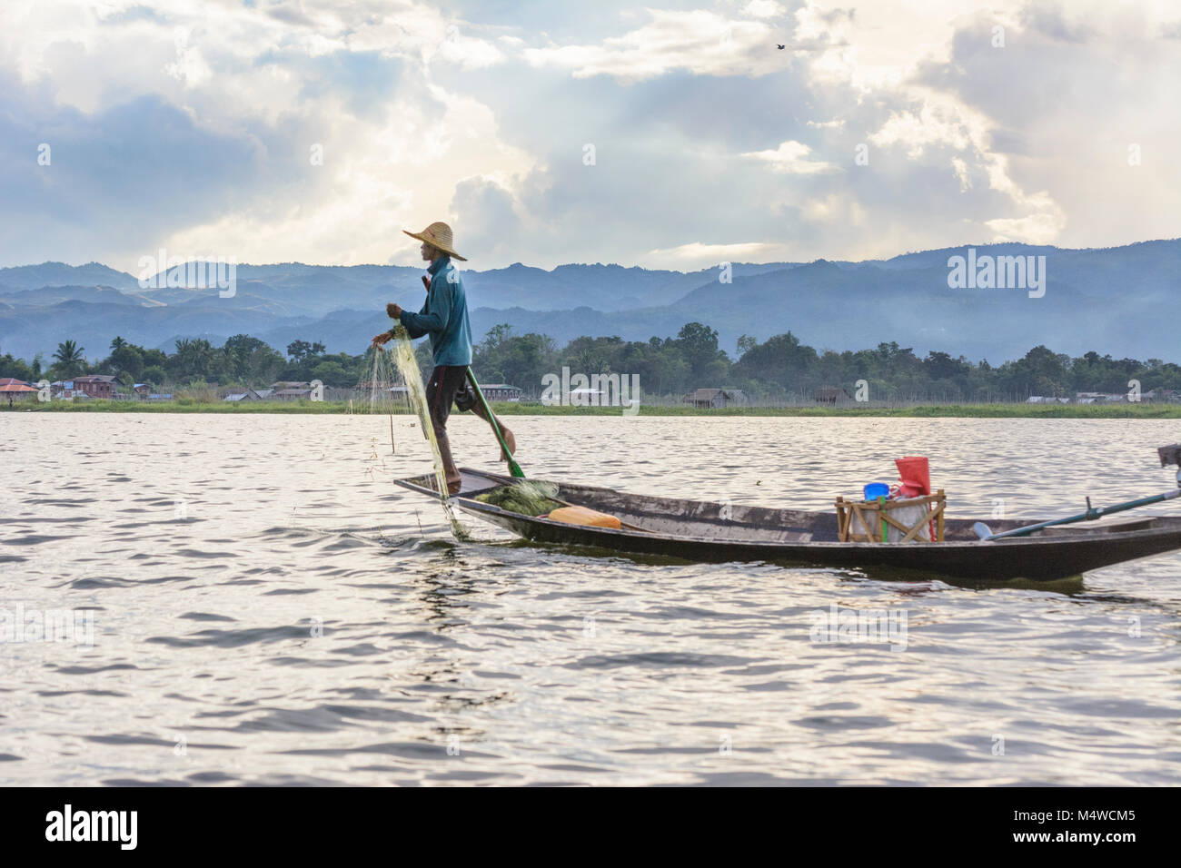 Nyaung Shwe: fisherman at Inle Lake, fishing net, leg rowing style ...