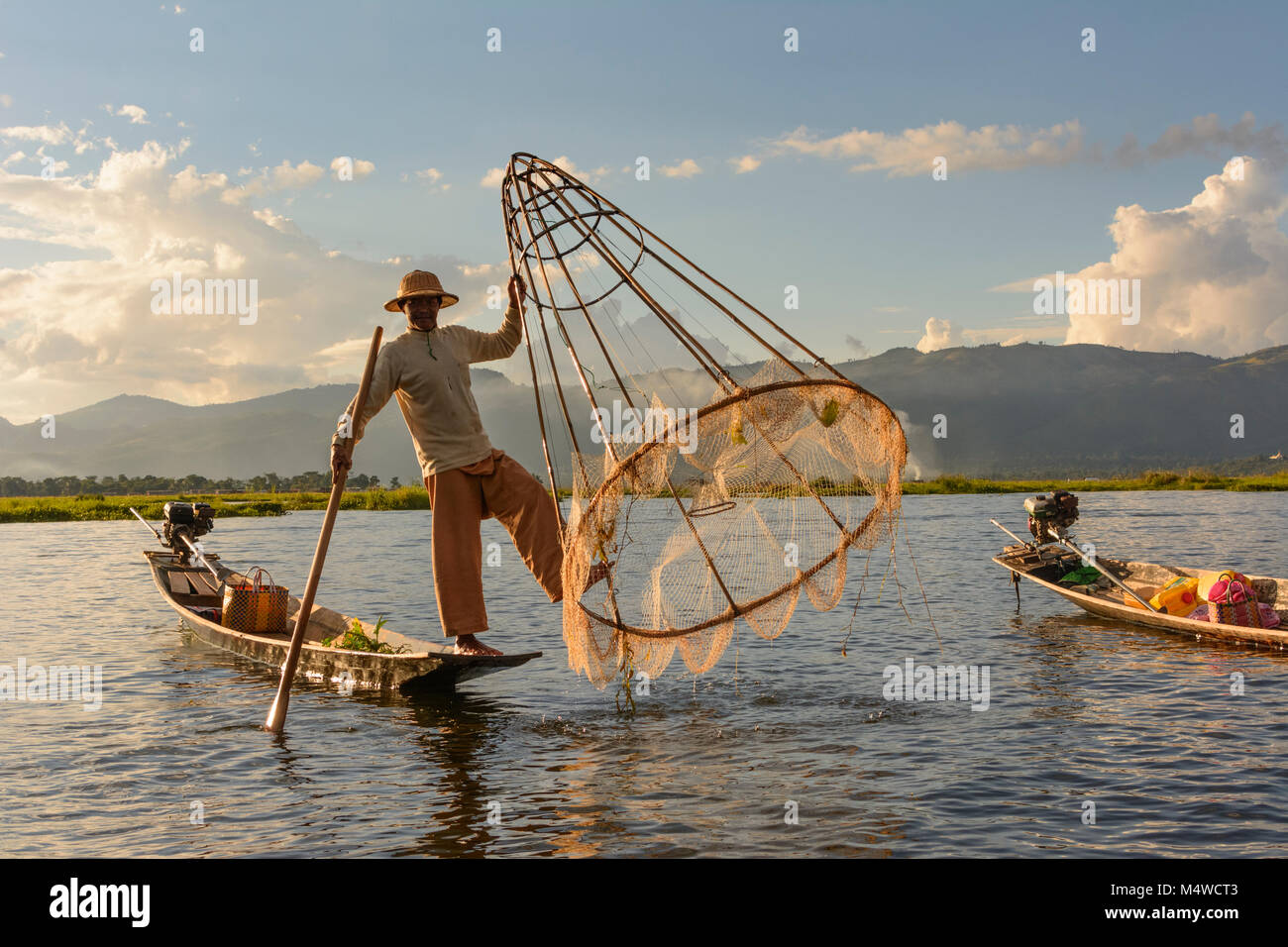 Nyaung Shwe: Fisherman at Inle Lake with traditional Intha conical net ...