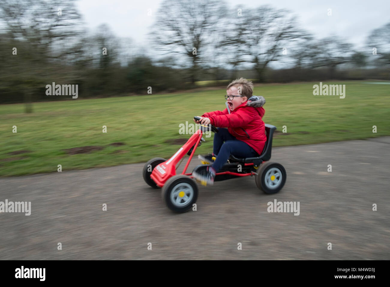 A young boy playing on his red pedal Go-Kart Stock Photo - Alamy
