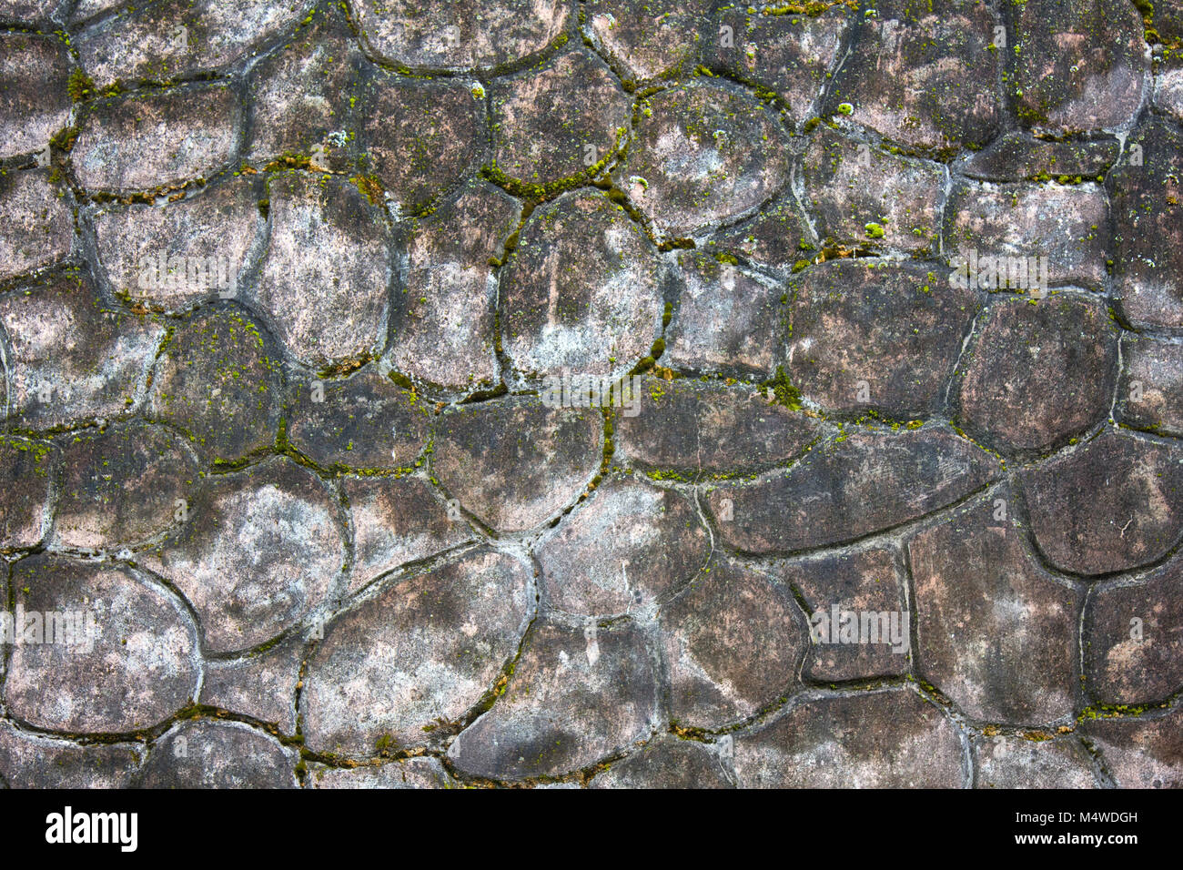 Part of old concrete pavement covered with rounded embossed pattern ...
