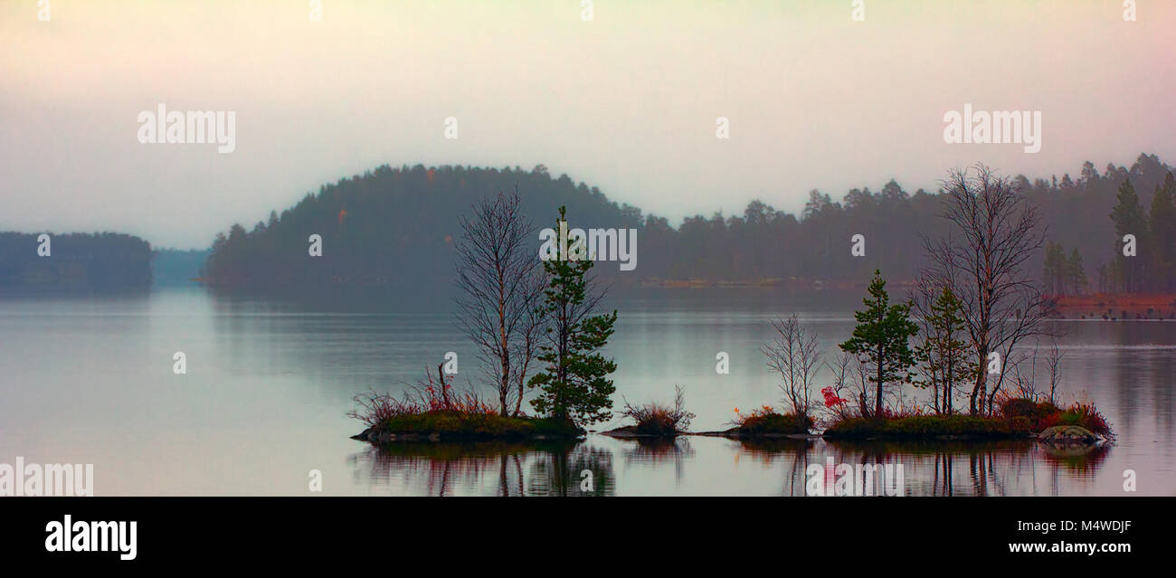 Brooding landscape with islets. Quiet sad fall day on serene lake, fog ...