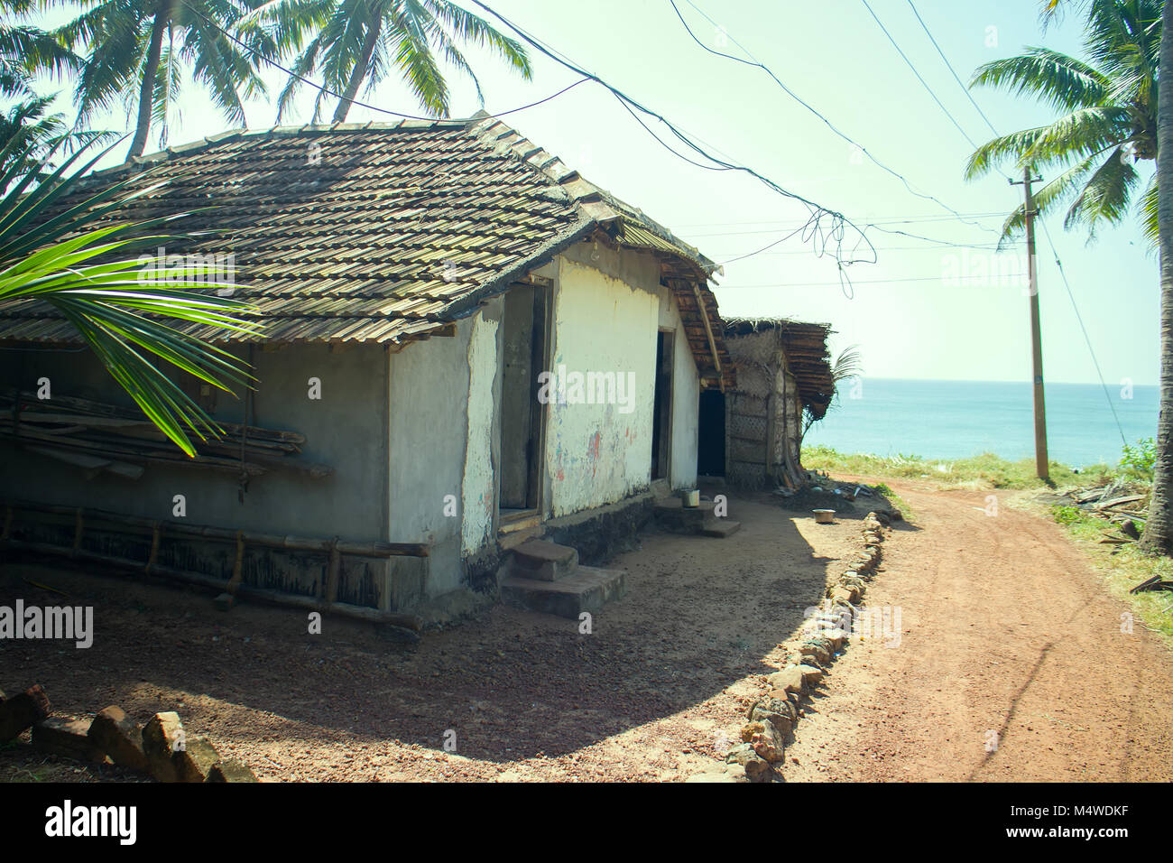 Poverty in prestigious location. Poor Indian house by Arabian sea ...