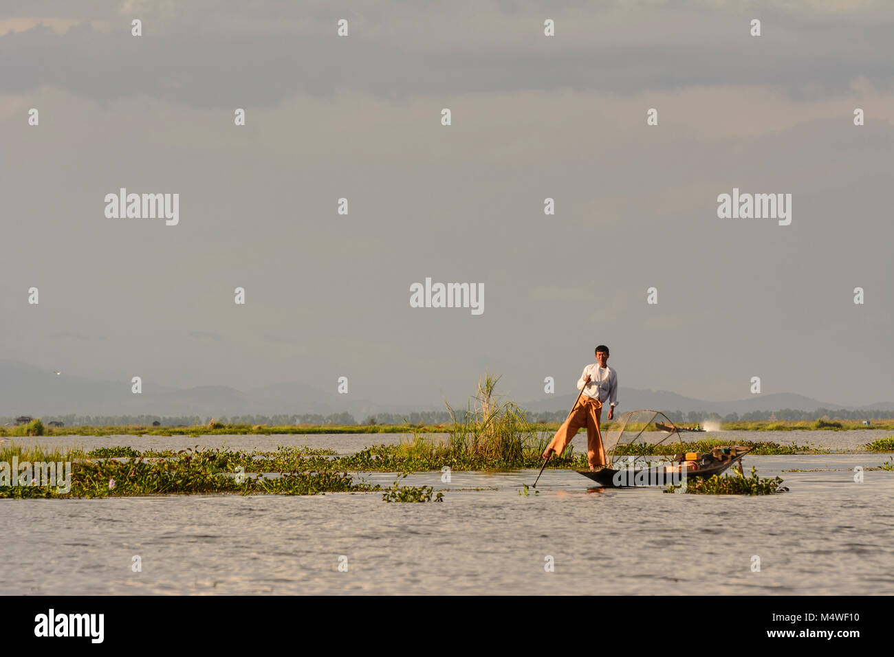 Nyaung Shwe: Fisherman at Inle Lake with traditional Intha conical net ...