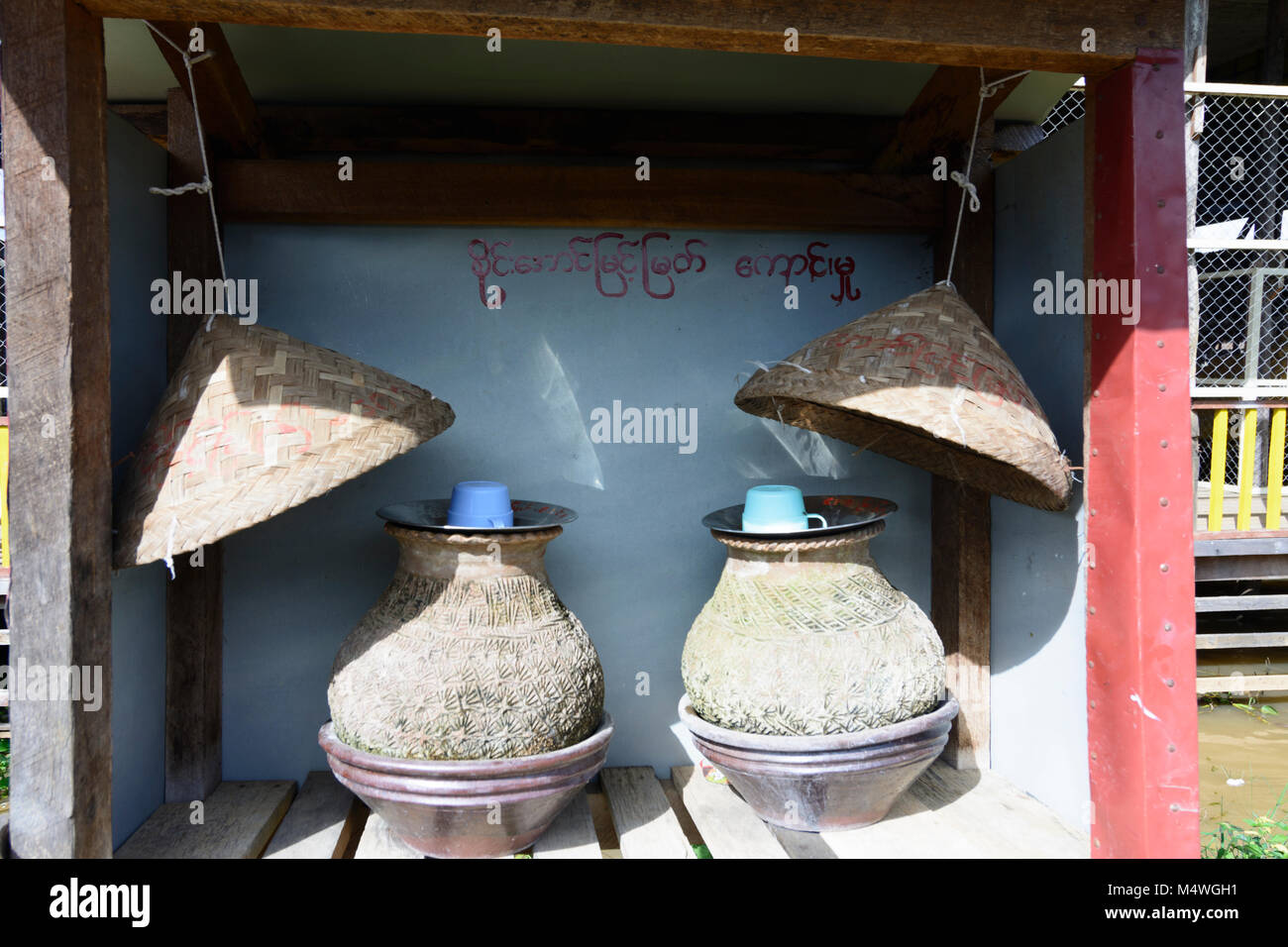 Tha Lay: drinking water in jar vessels donated for merits, Inle Lake ...