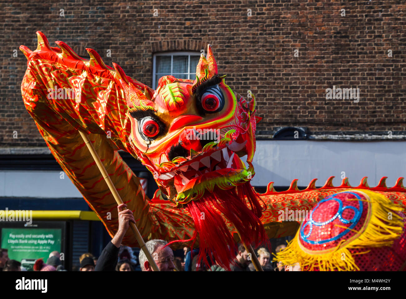 The orange coloured dragon twists and turns towards the camera during ...