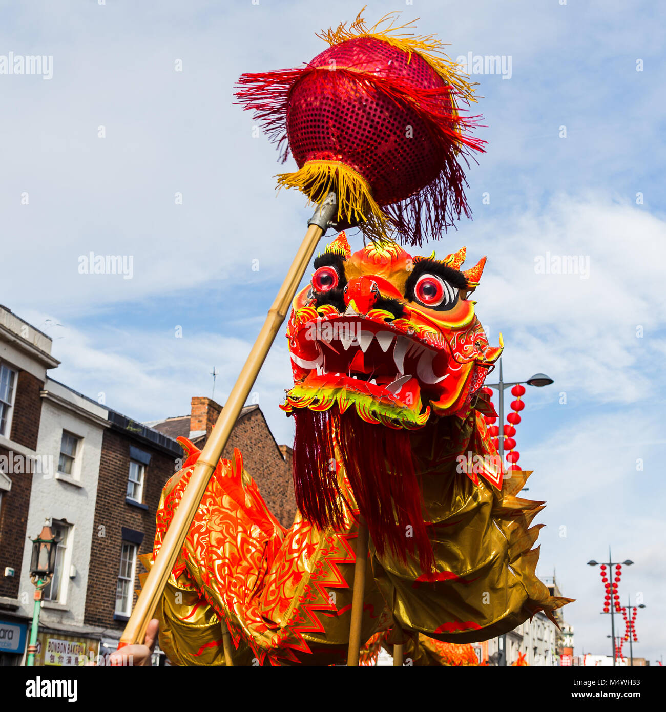 The vivid orange, red and yellow coloured dragon chases the pearl ...