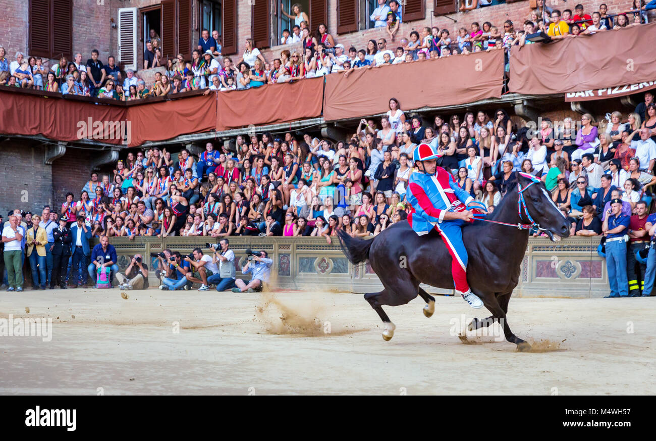 The Palio di Siena horse race on Piazza del Campo, Siena, Tuscany ...