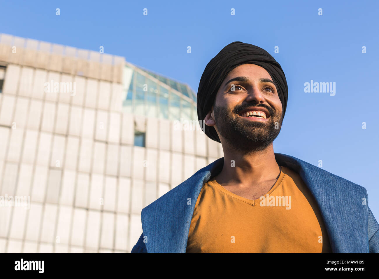 Handsome Indian man posing in an urban context. Street fashion and ...