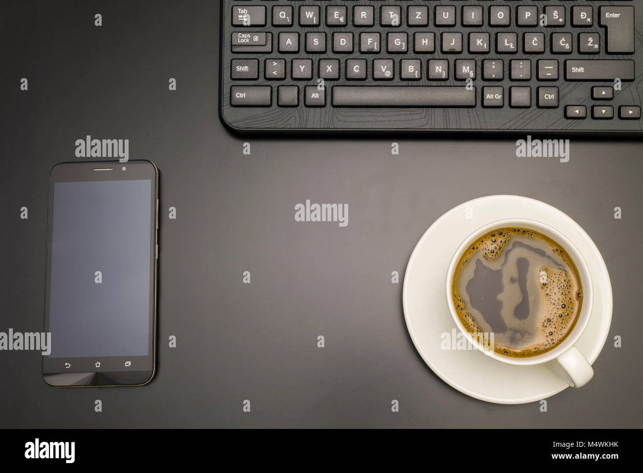 Office work space with phone,coffee and keyboard Stock Photo - Alamy