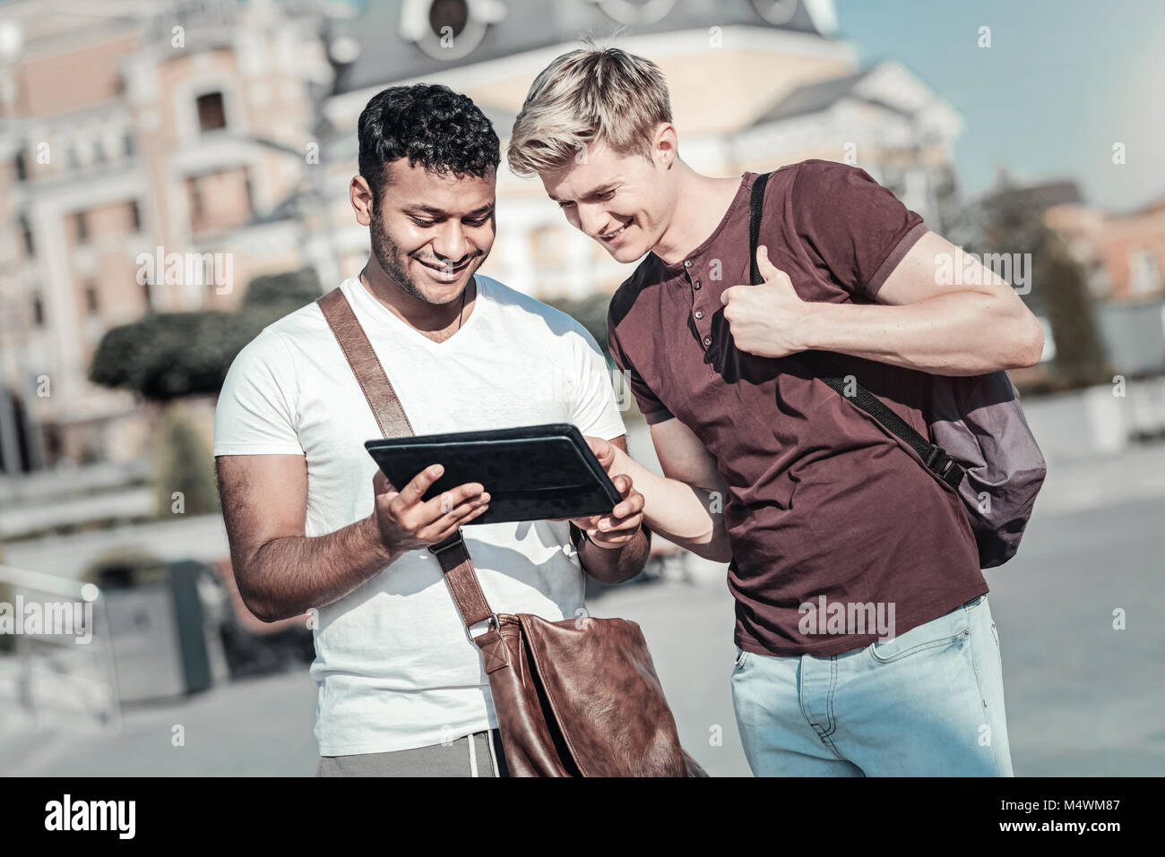 Positive young man talking to his friend Stock Photo - Alamy