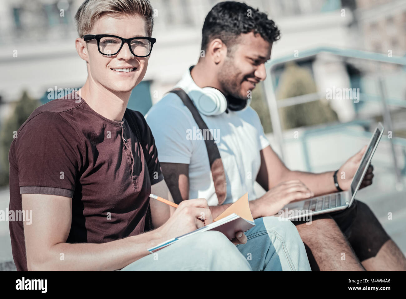 Nice smart student taking notes Stock Photo - Alamy