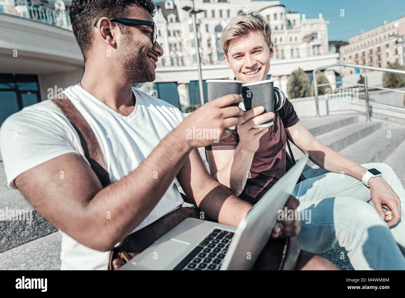 Happy nice students cheering with coffee Stock Photo - Alamy