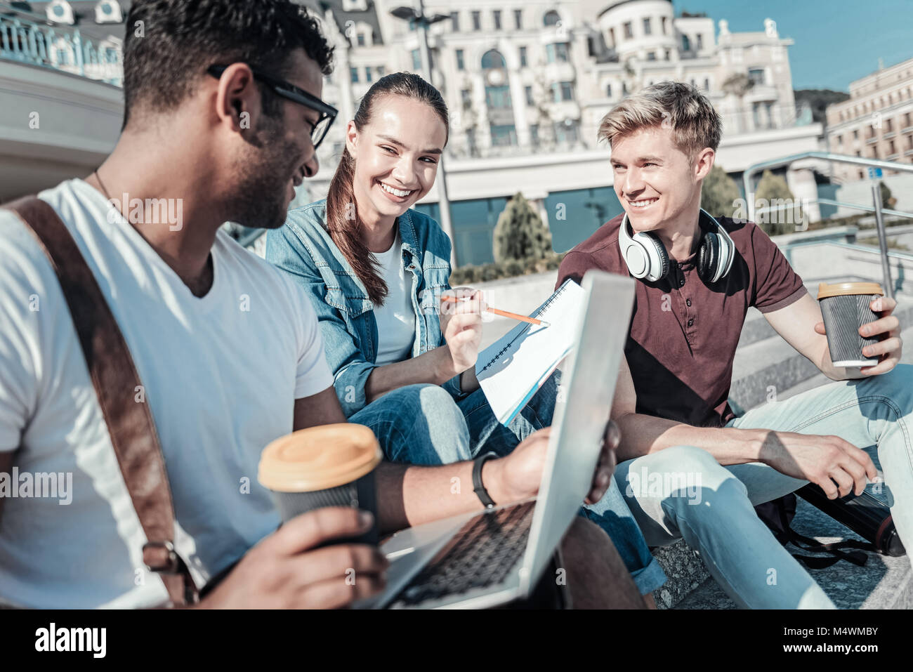 Happy positive students studying together Stock Photo - Alamy