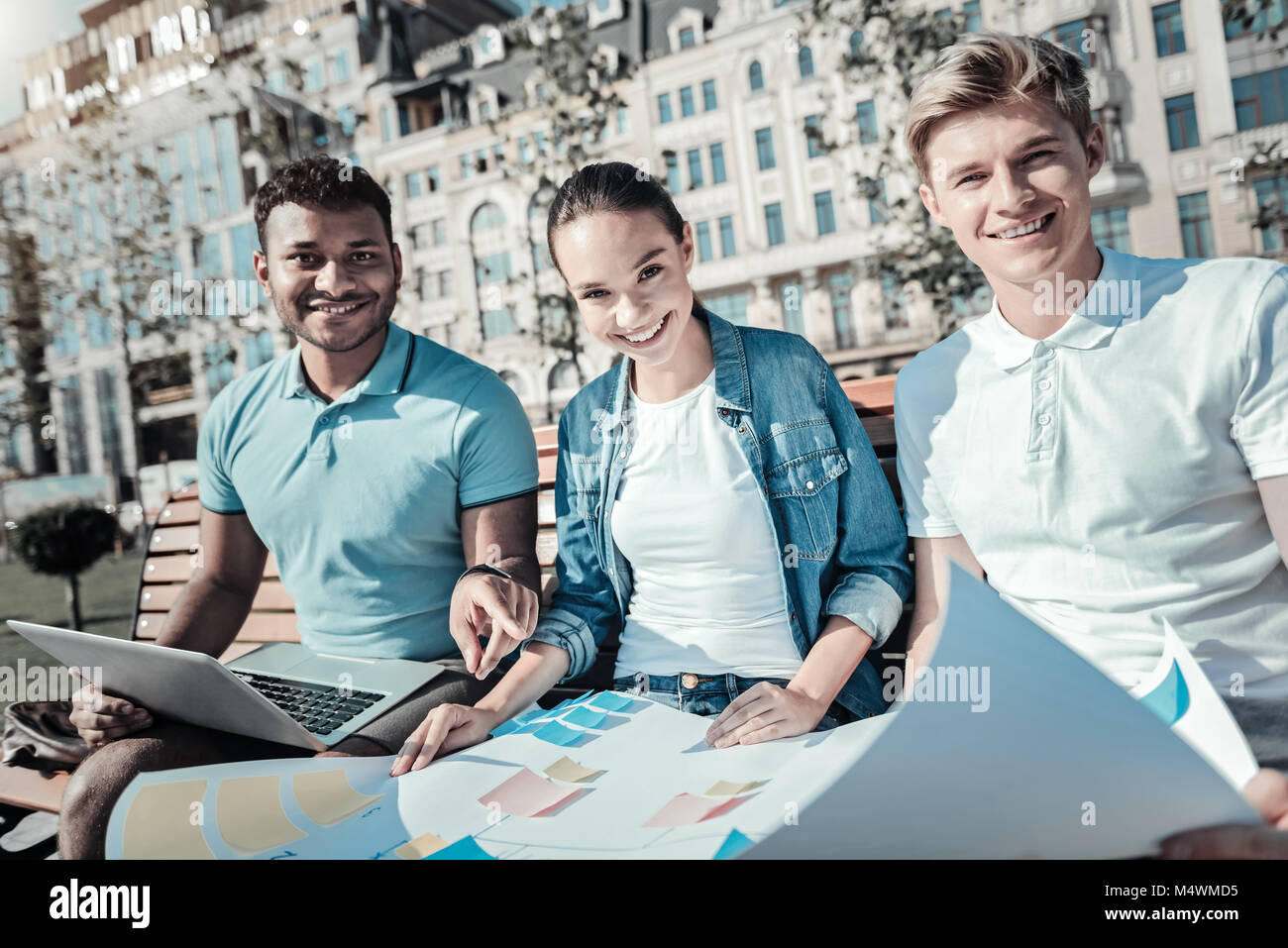 Delighted happy students working in team Stock Photo - Alamy