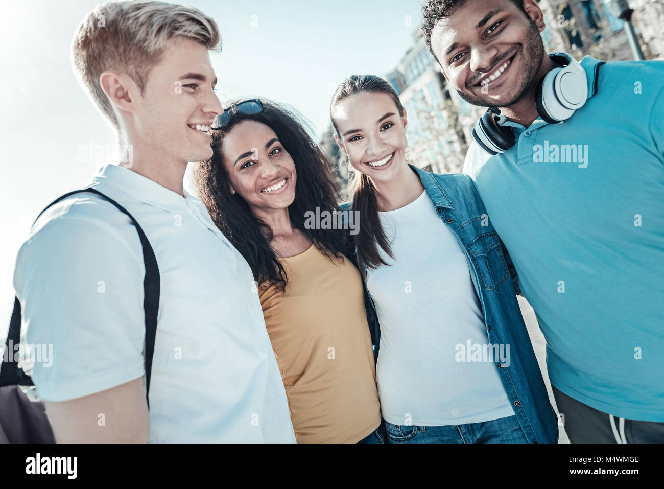 Happy nice students standing together Stock Photo - Alamy