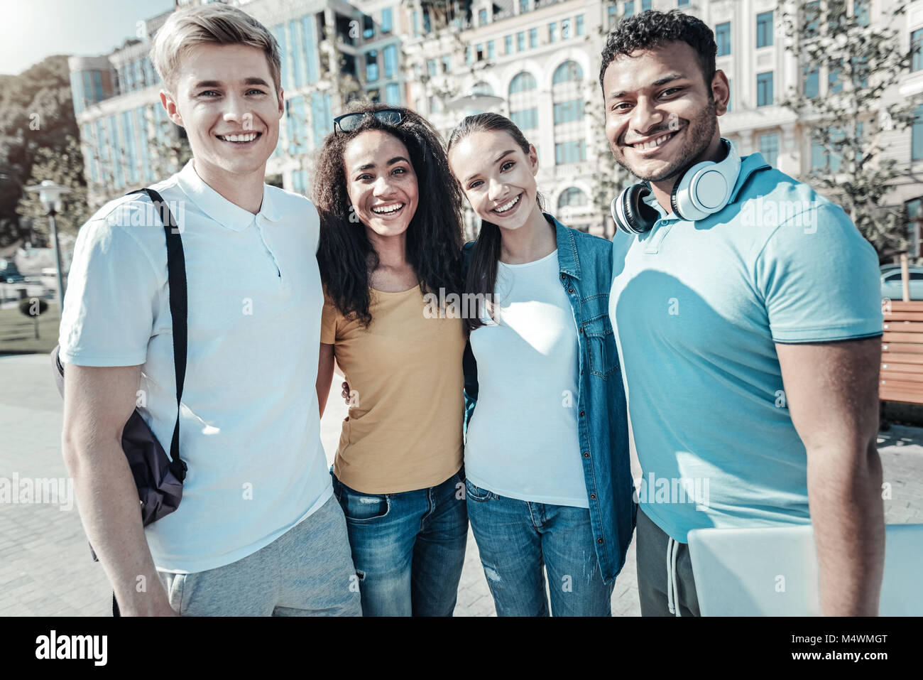 Happy joyful friends standing together Stock Photo - Alamy