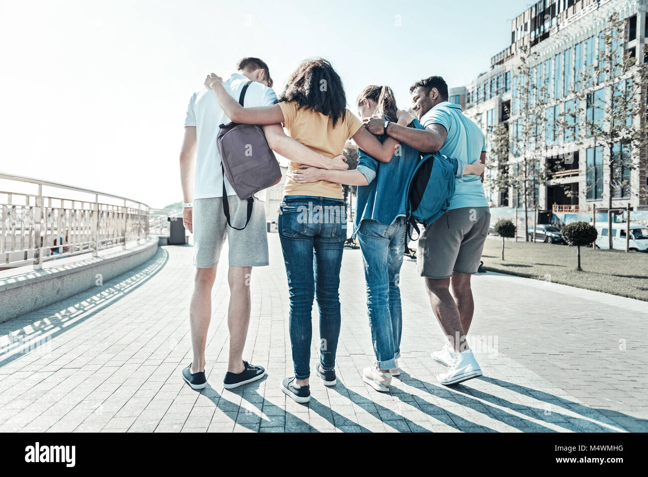 Happy nice friends walking together Stock Photo - Alamy