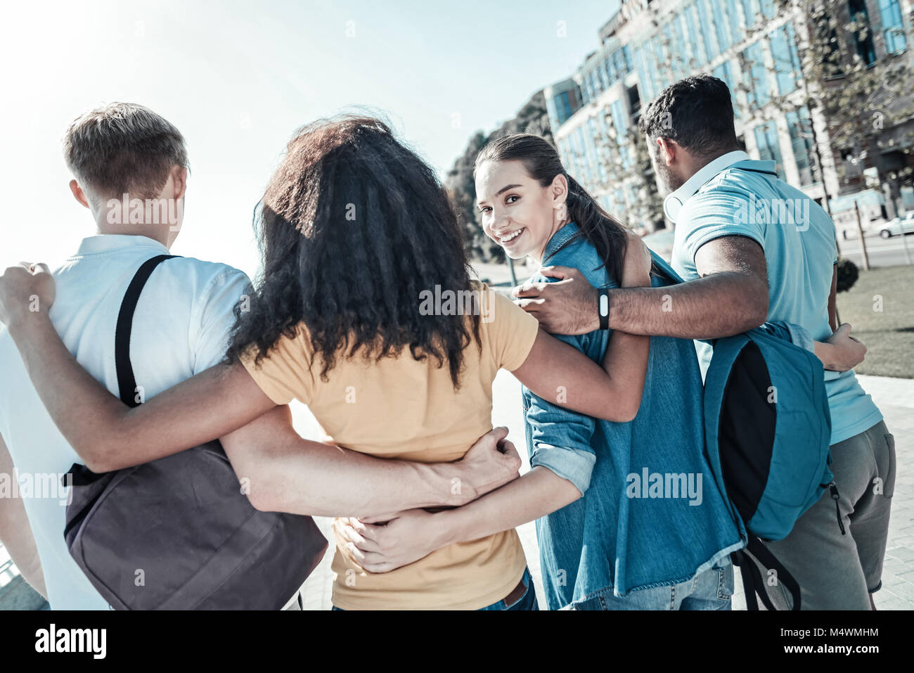 Nice happy friends holding on to each other Stock Photo - Alamy
