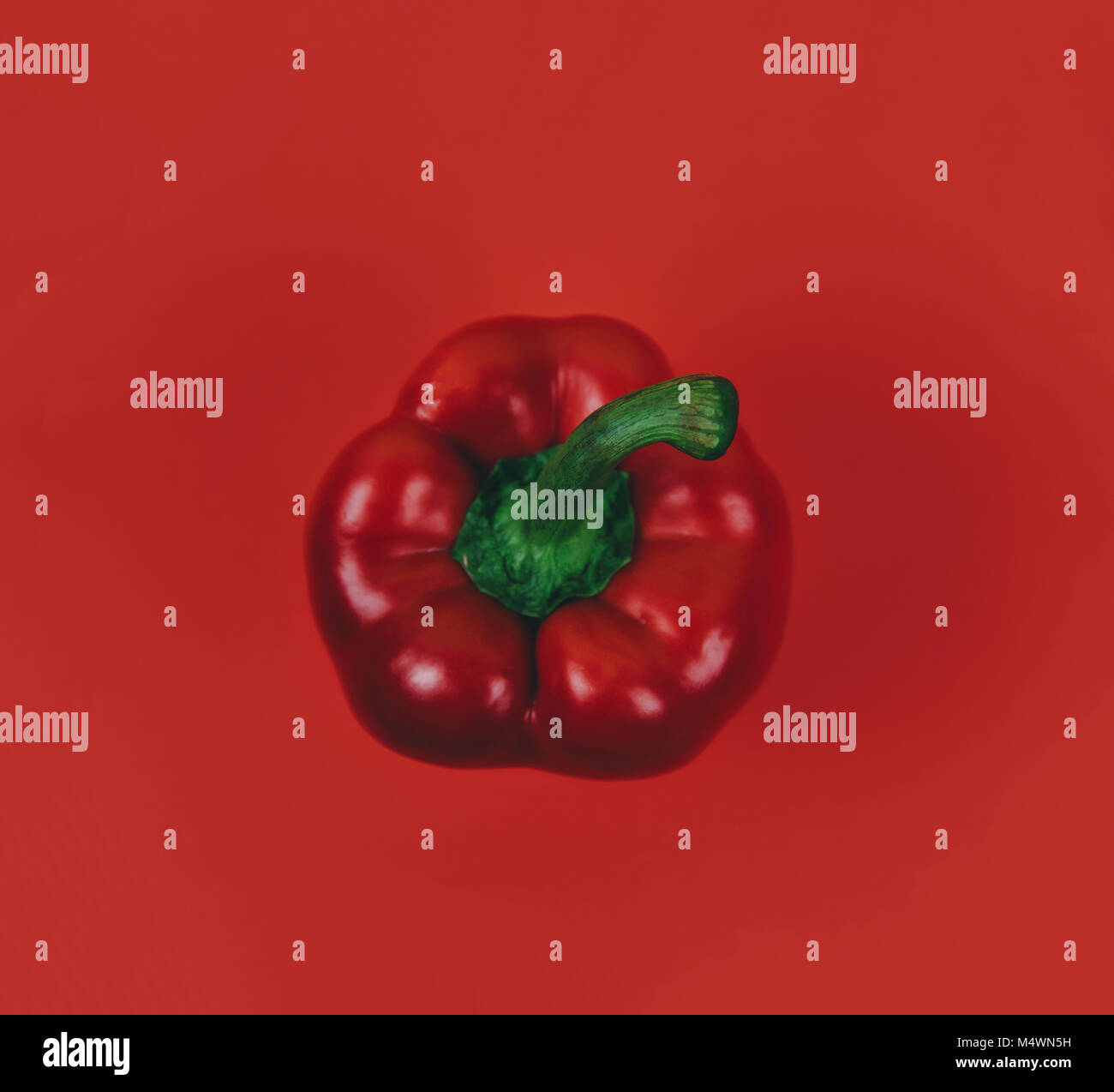 Red pepper on bright red background, top view Stock Photo - Alamy