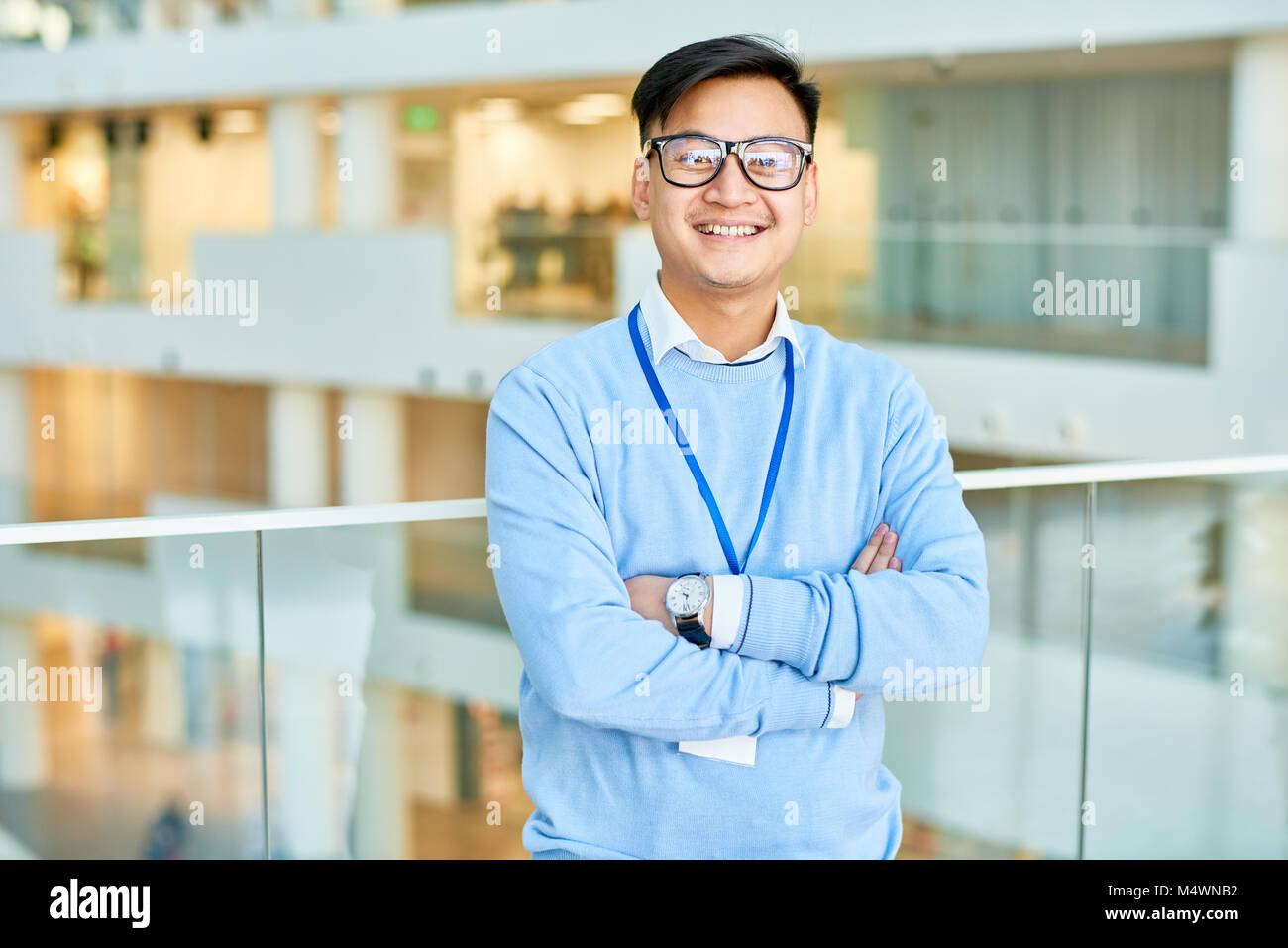Waist Up Portrait Of Cheerful Asian Businessman Wearing Glasses Smiling