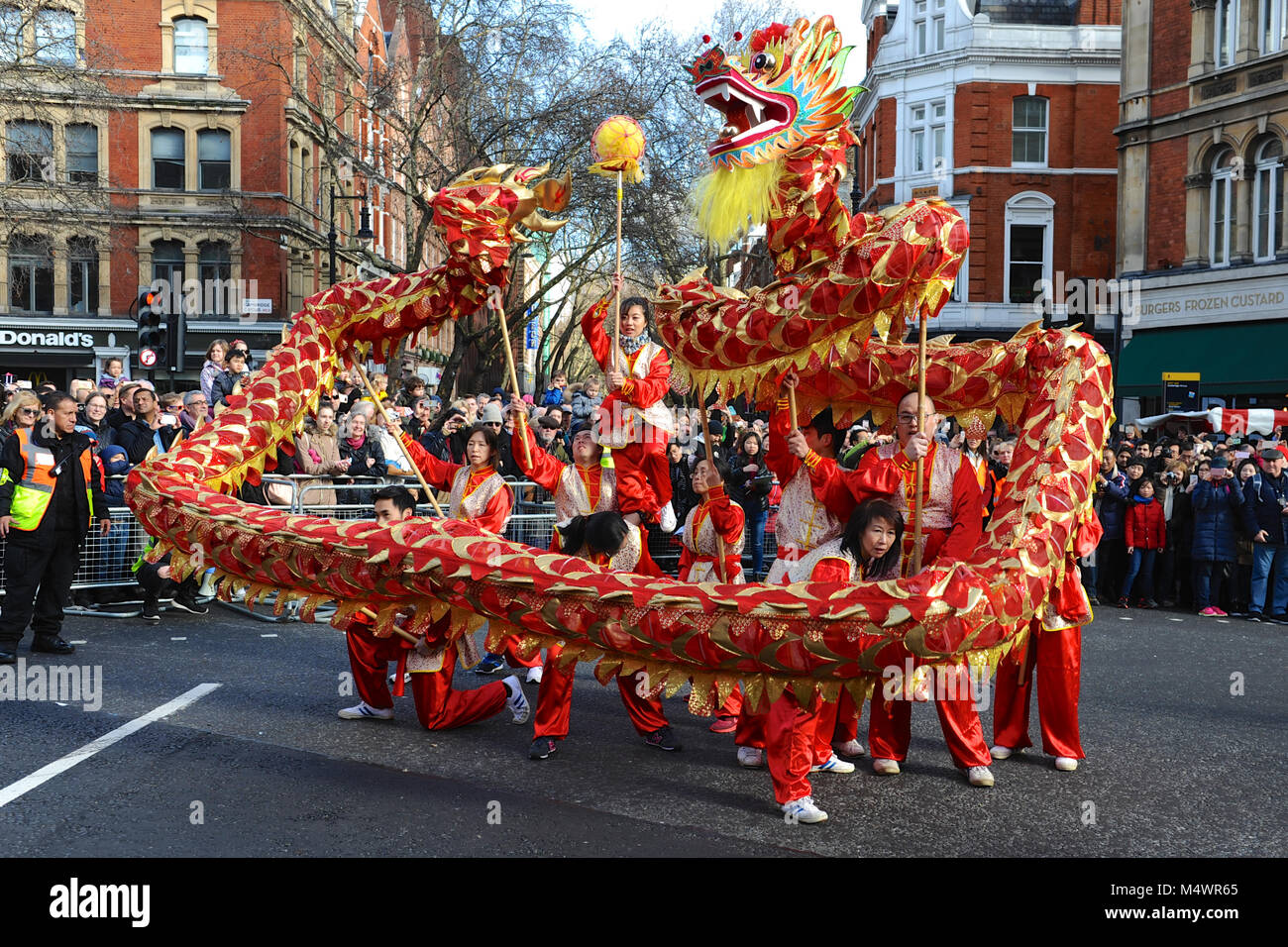 A ceremonial dragon is danced through the streets of Chinatown, London ...