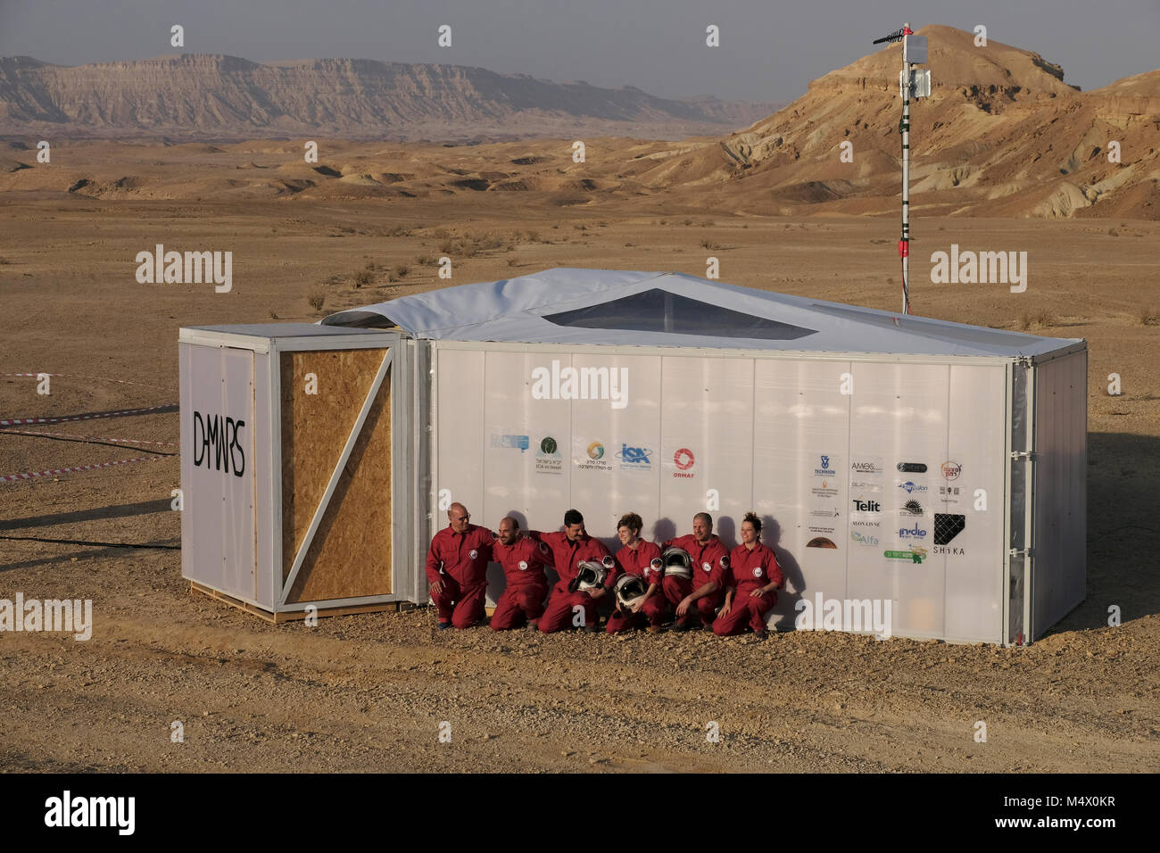 Analog astronauts, sit in front of the Mars-like research facility ...