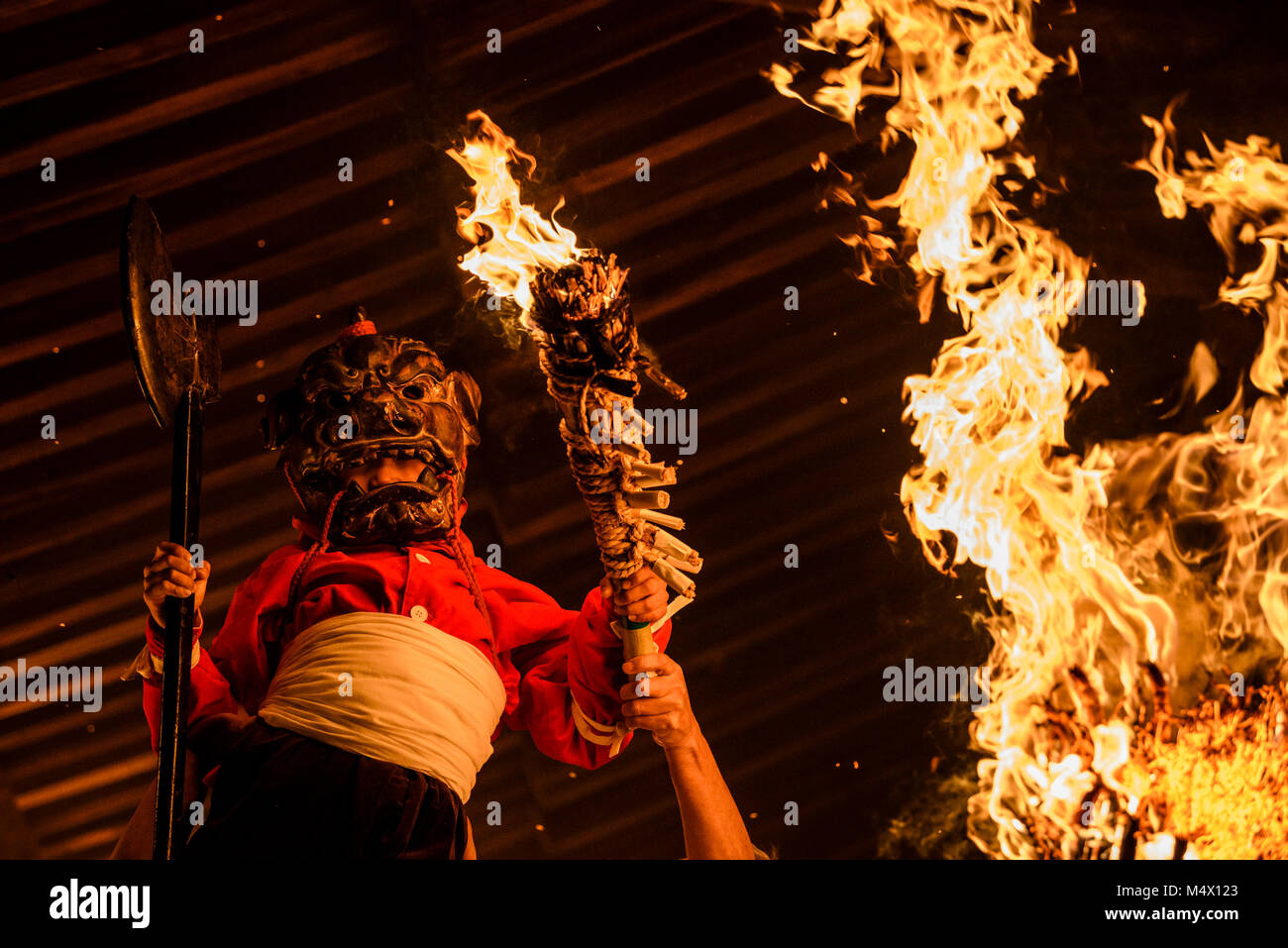 FEBRUARY 17, 2018 - A boy wearing an ogre mask is held aloft next to ...