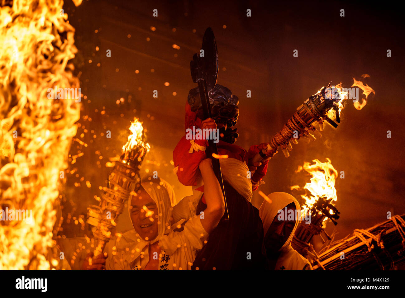 FEBRUARY 17, 2018 - A boy wearing an ogre mask is held aloft next to ...